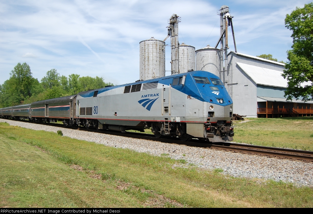 Amtk P-42DC #80 leads a southbound past the old mill